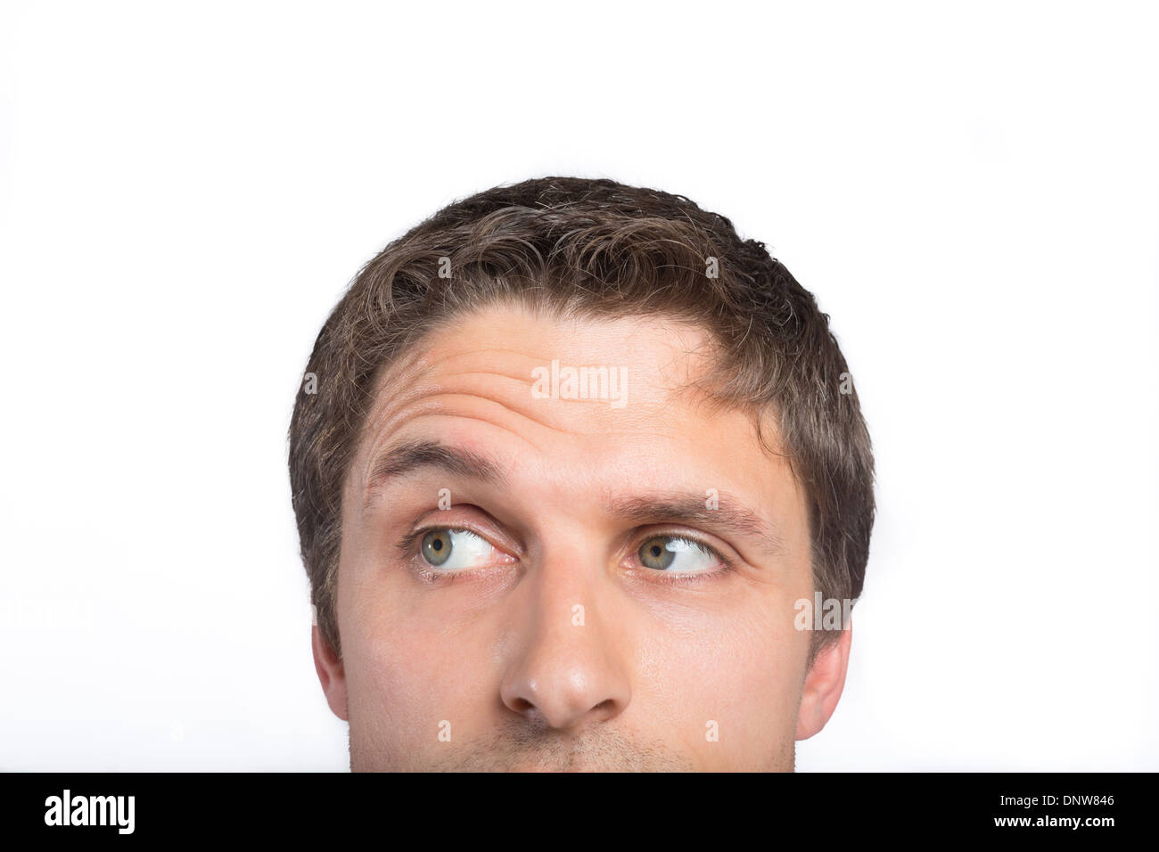 Close-up of a green eyed man raising eyebrow Stock Photo - Alamy