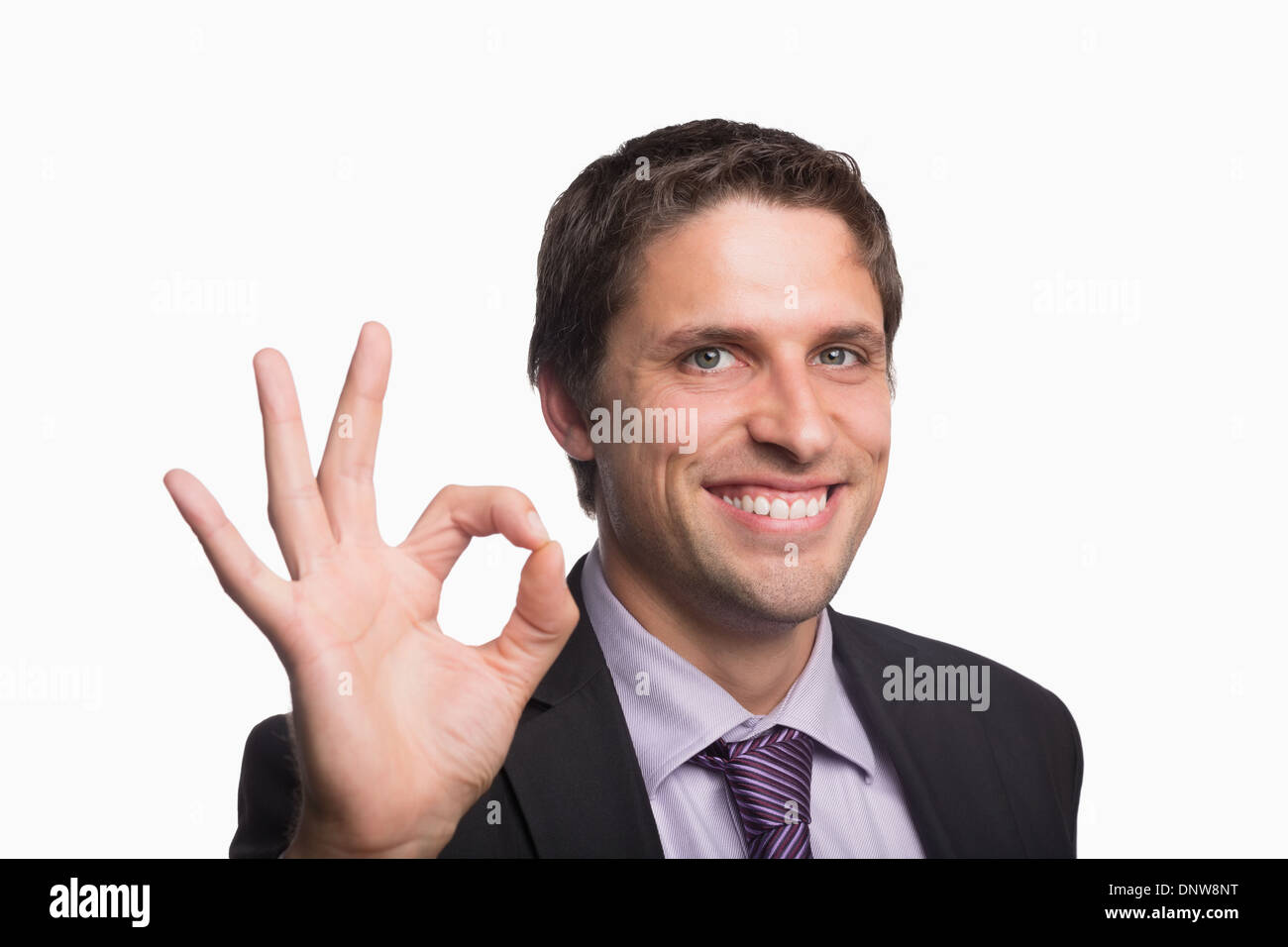 Cheerful businessman gesturing okay sign Stock Photo - Alamy