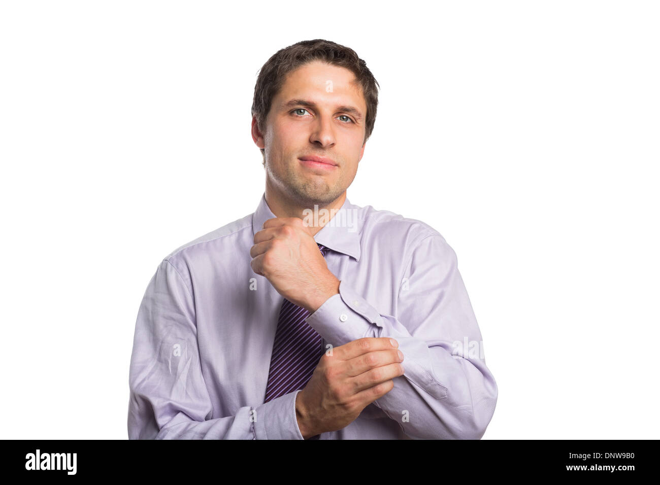 Young businessman adjusting shirt sleeves Stock Photo - Alamy