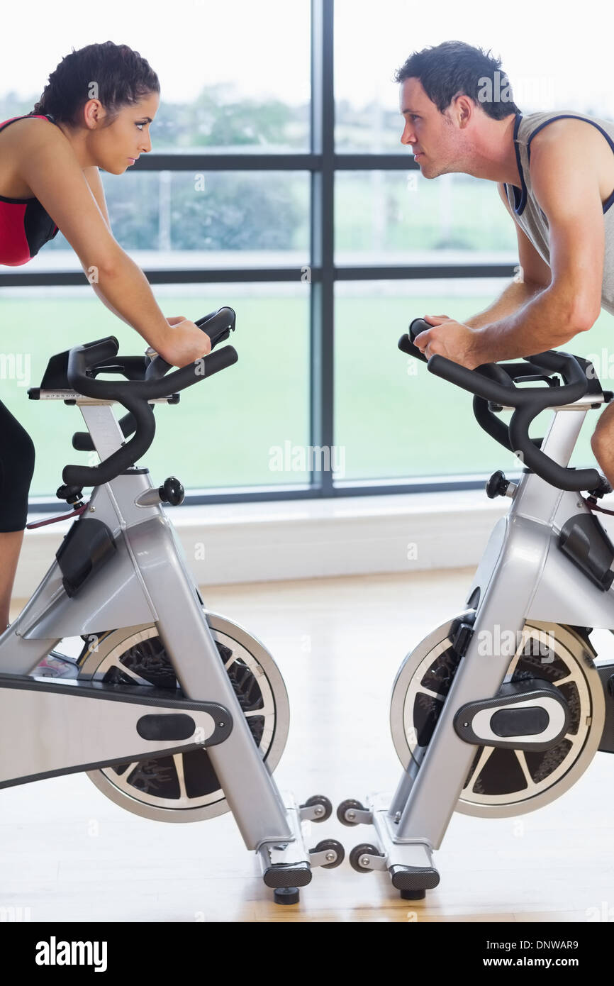 Side view of a woman and man working out at spinning class Stock Photo ...
