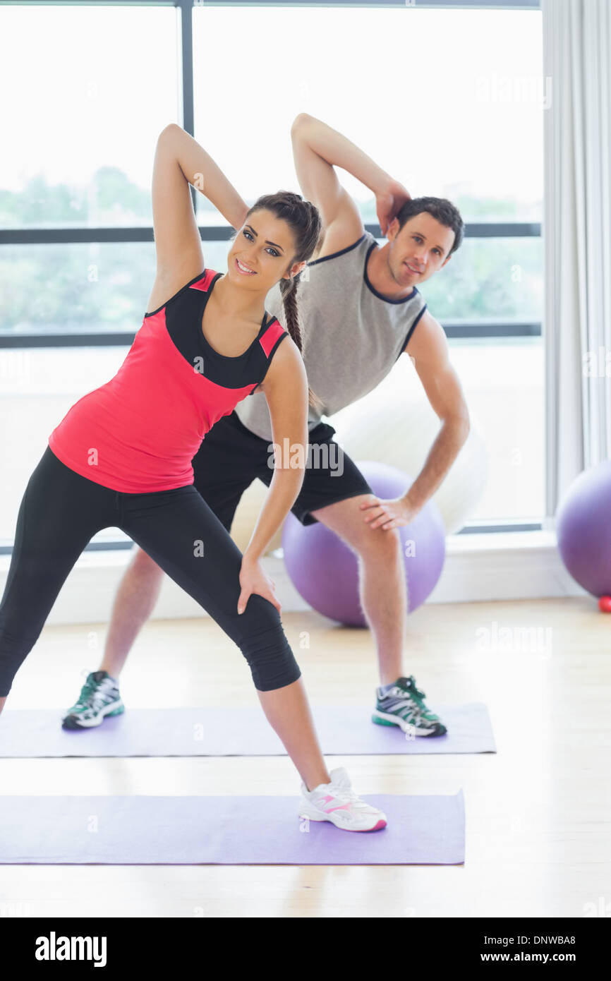 Two people doing power fitness exercise at yoga class Stock Photo - Alamy