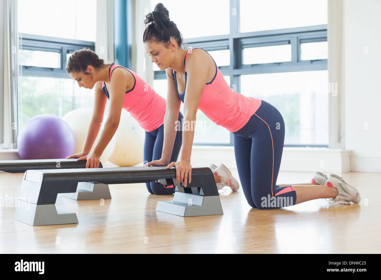 Fit women performing step aerobics exercise in gym Stock Photo - Alamy