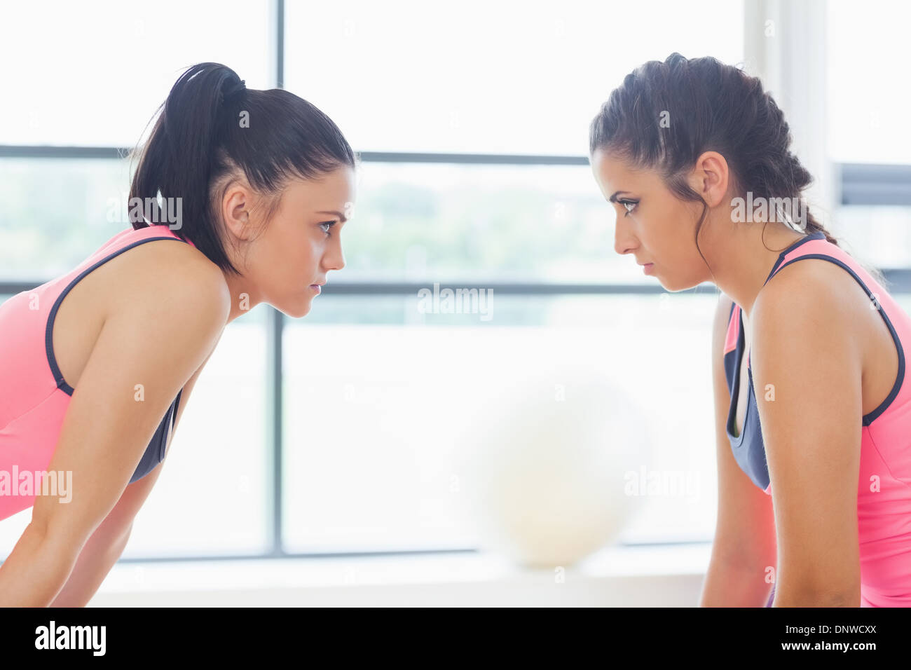 Two angry women staring at each other at a gym Stock Photo - Alamy