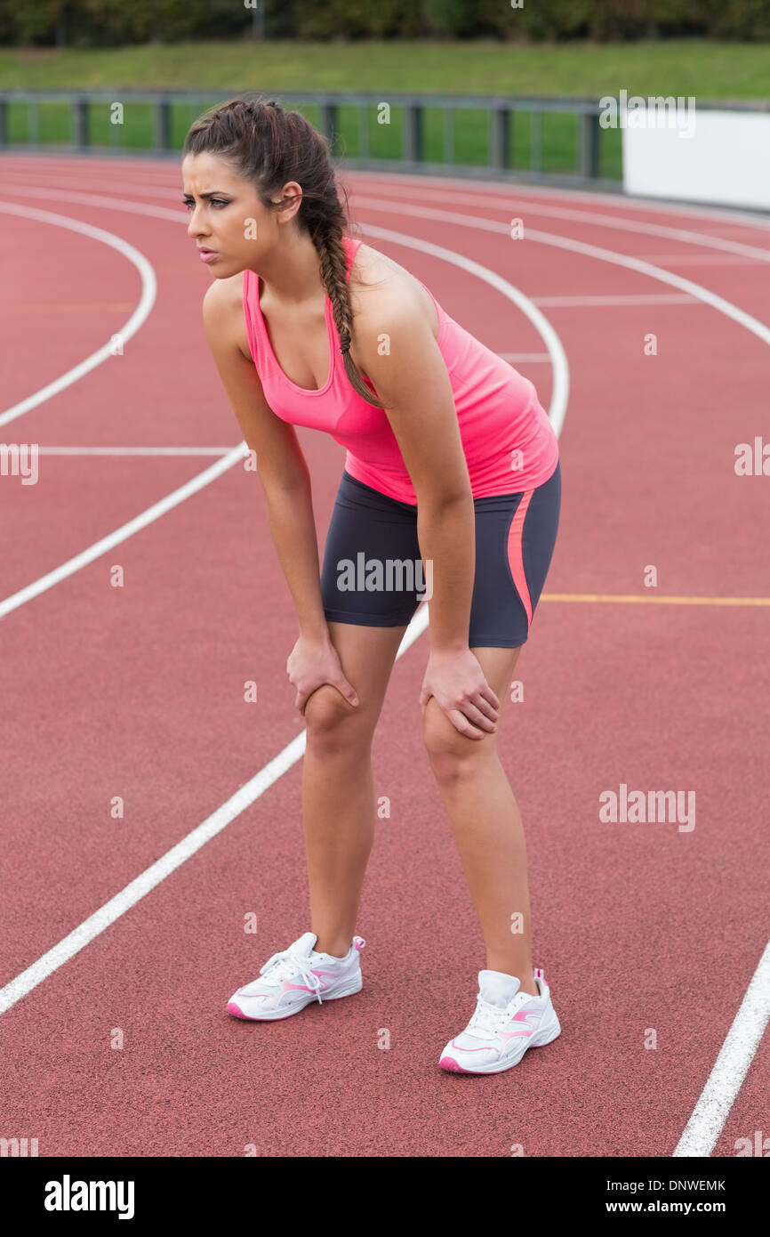 TIred sporty woman on the running track Stock Photo - Alamy