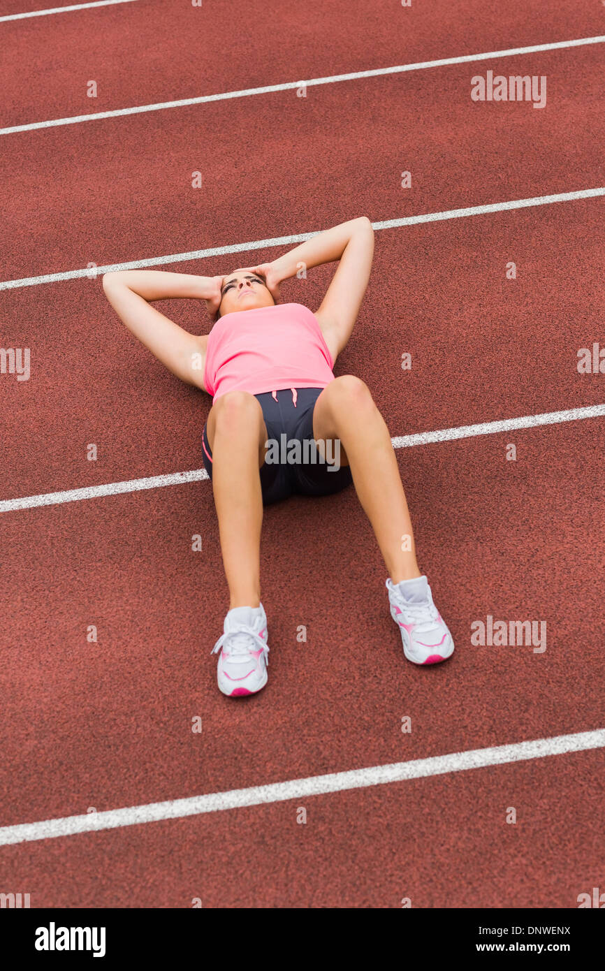 Sporty woman suffering from headache on the running track Stock Photo ...