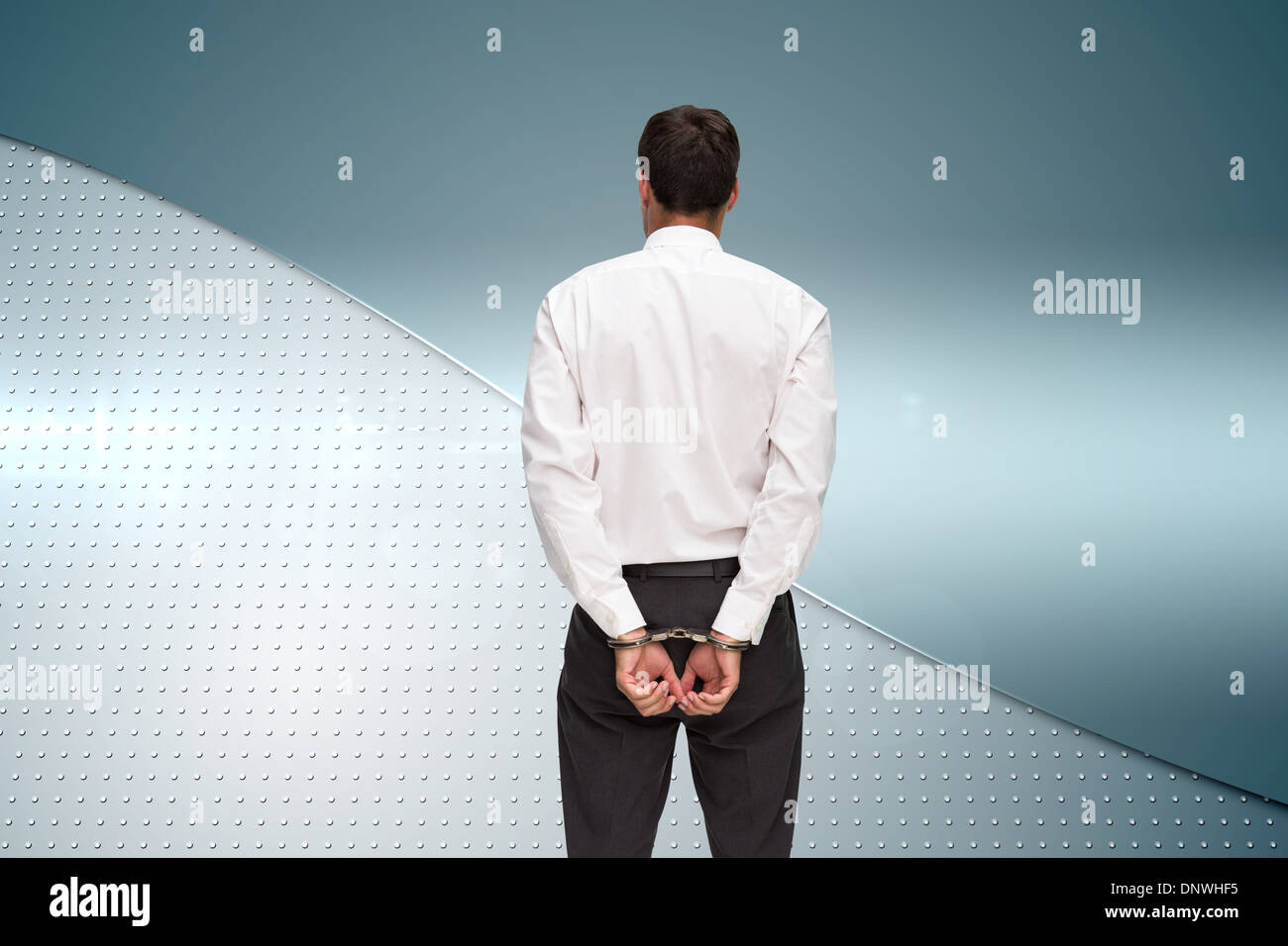 Composite image of rear view of young businessman wearing handcuffs ...