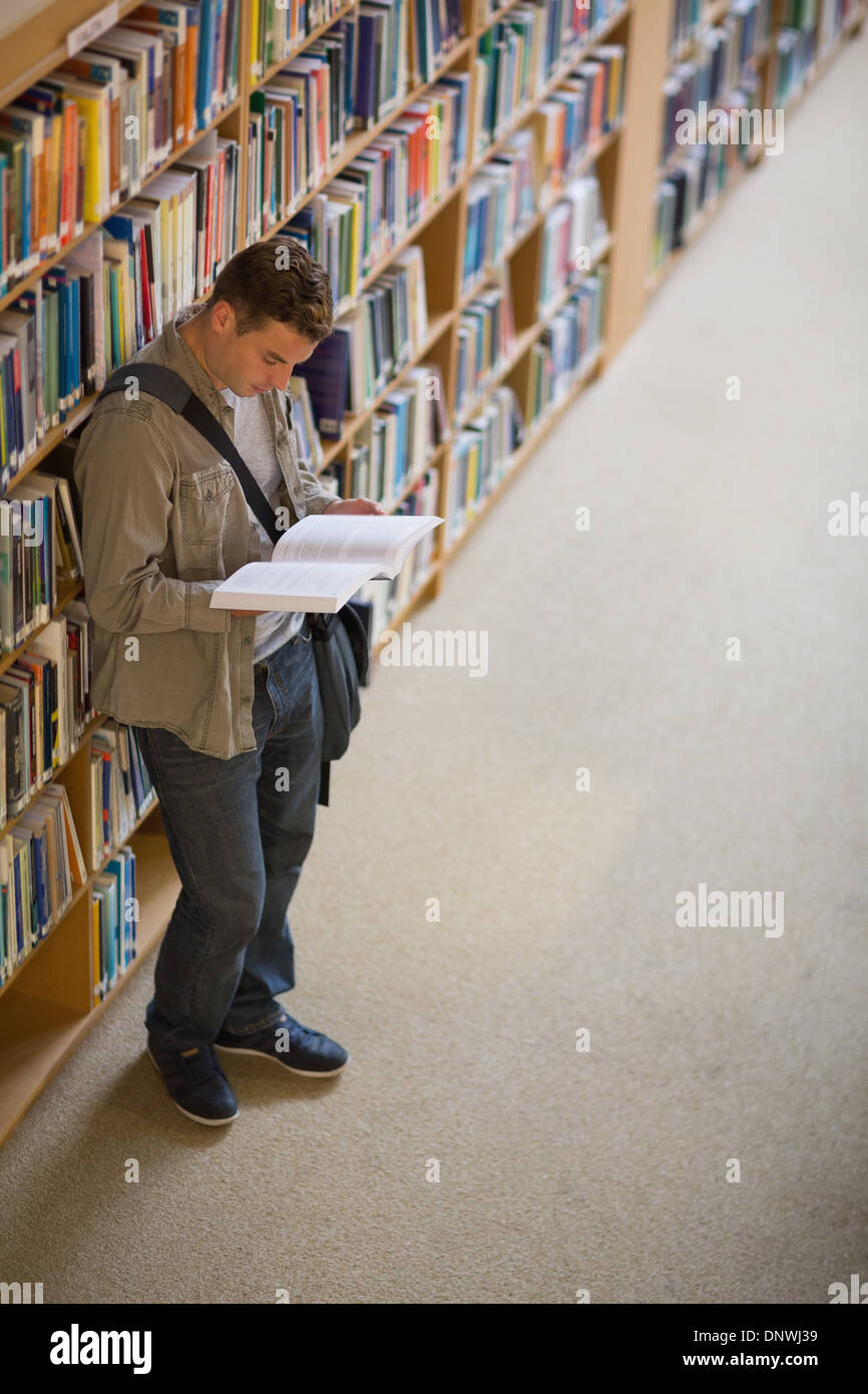Serious student holding book in hi-res stock photography and images - Alamy