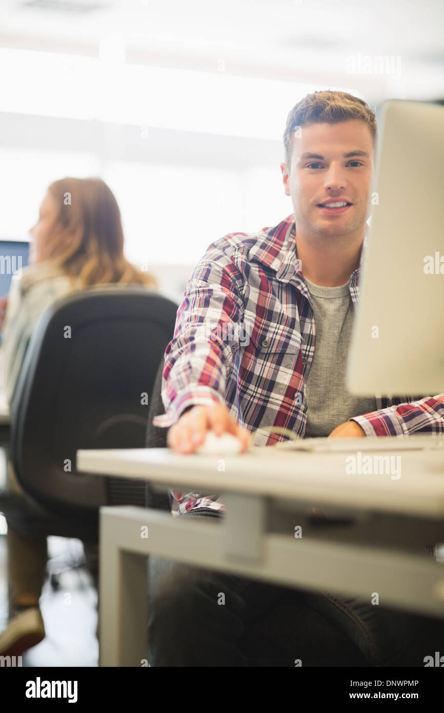 Happy student looking at camera in the computer room Stock Photo - Alamy