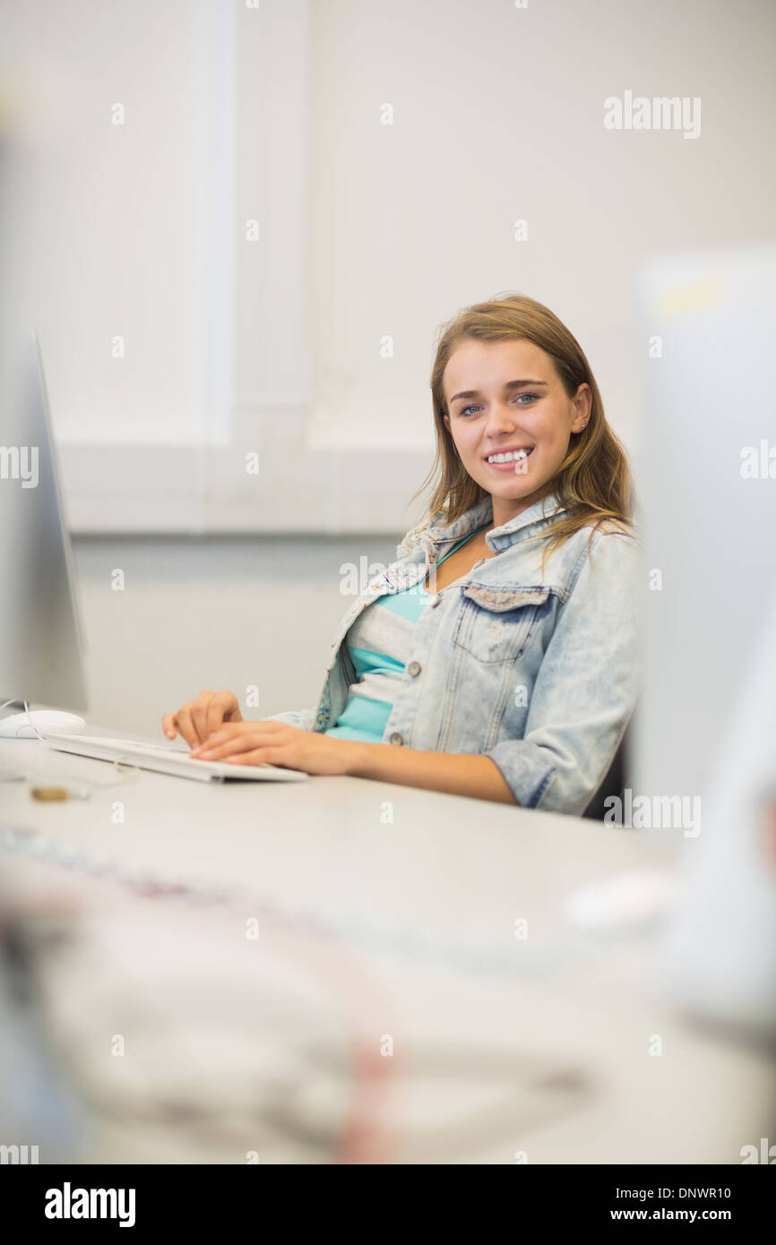 Smiling student studying in the computer room Stock Photo - Alamy
