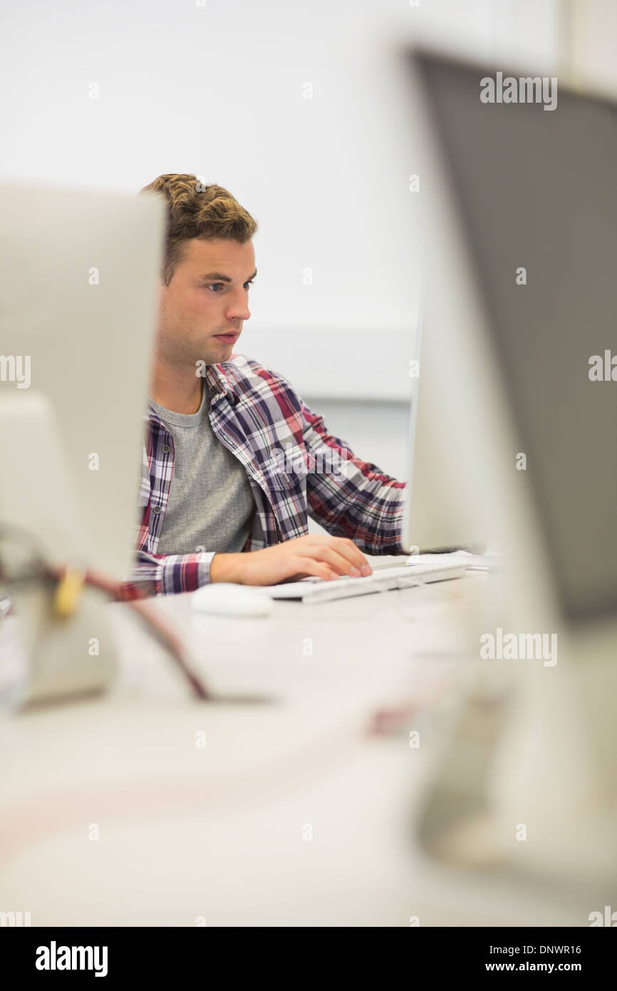 Focused handsome student studying in the computer room Stock Photo - Alamy
