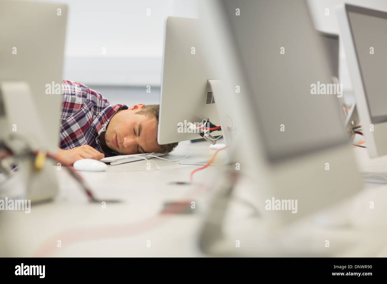 Handsome student napping in the computer room Stock Photo - Alamy