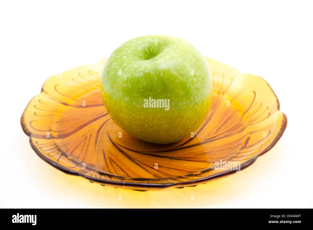 Green apple with glass plate Stock Photo - Alamy