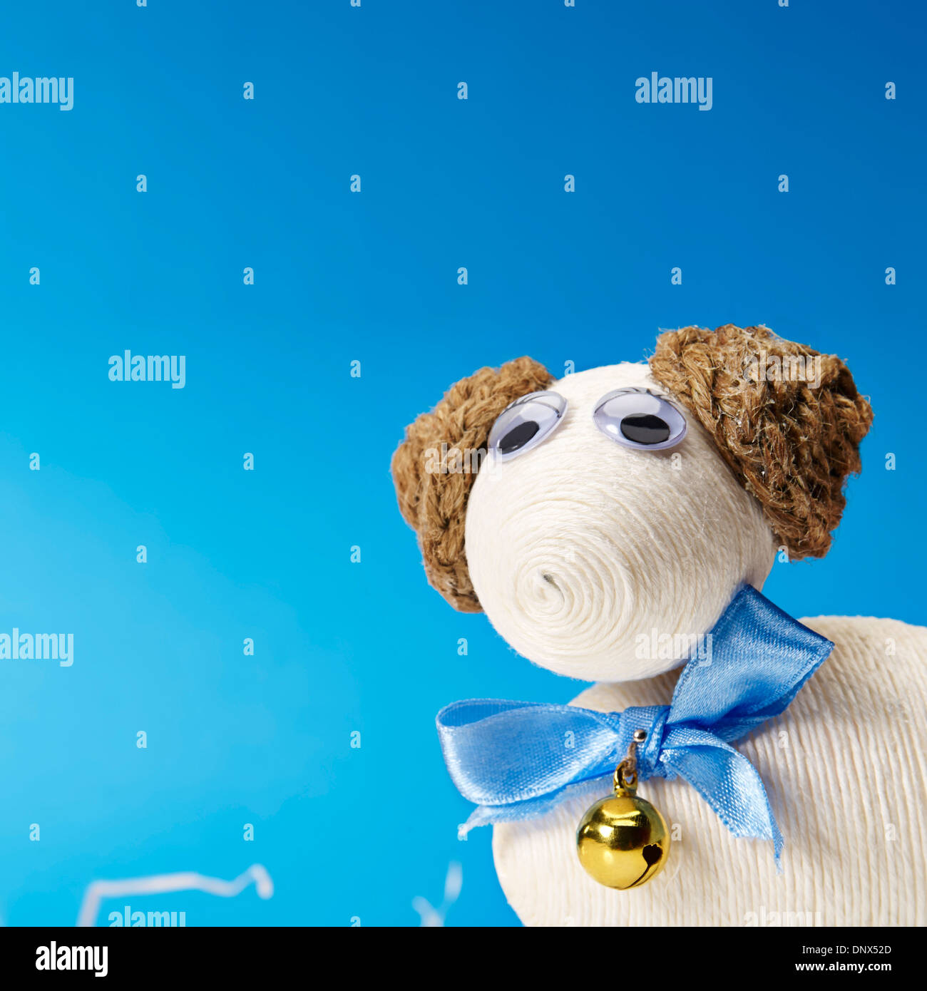 Easter lamb with blue bow and gold bell on the blue background. Copy ...