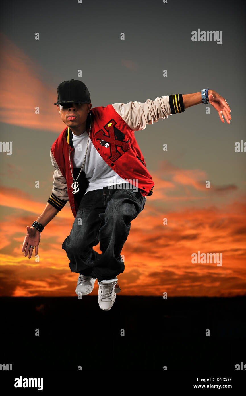 African American hip hop dancer jumping with sunset background Stock ...