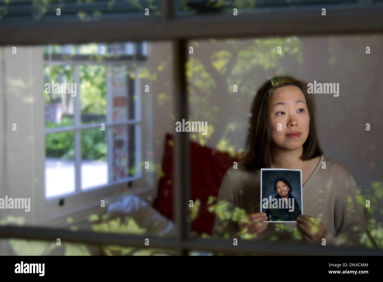 Dec 12, 2005; Belmont, CA, USA; Jannice Pang holding a picture of her ...