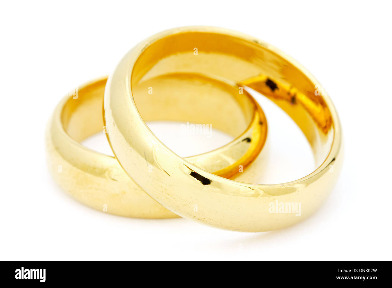 Two golden wedding rings on a white background Stock Photo - Alamy