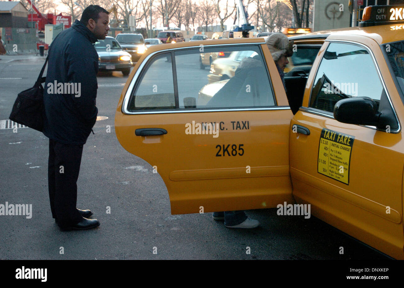 Dec 20, 2005; Manhattan, New York, USA; Commuters hail taxi cabs in ...