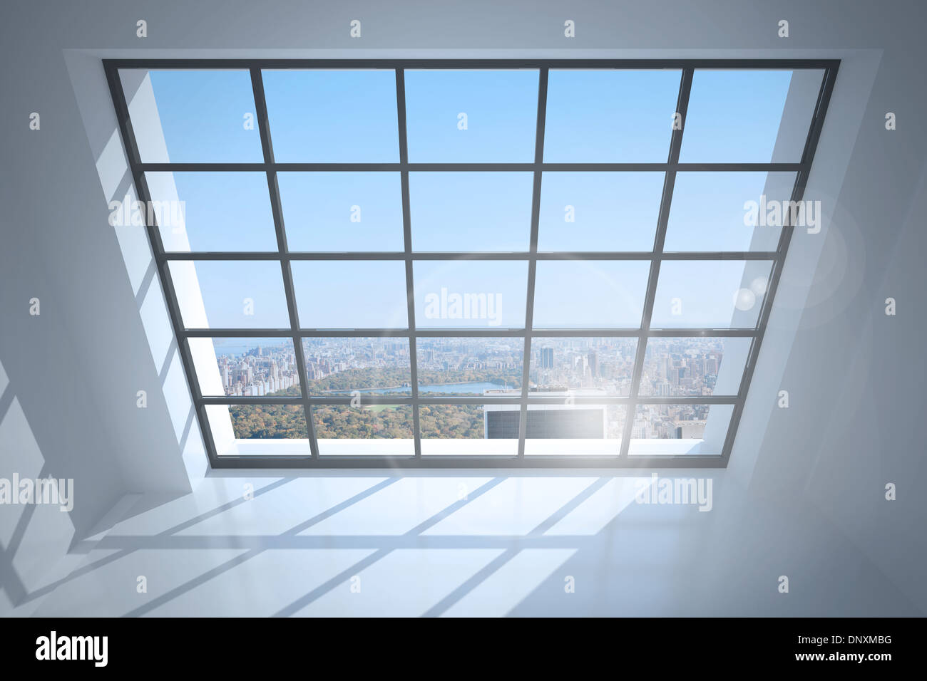 Room with large windows showing city Stock Photo - Alamy