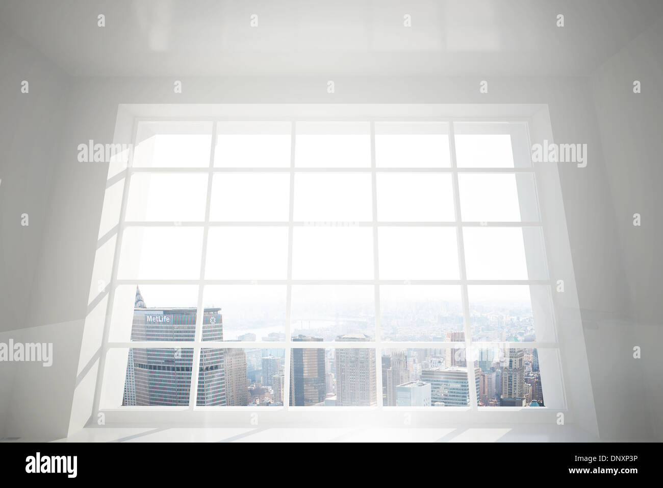 Room with large window showing city Stock Photo - Alamy