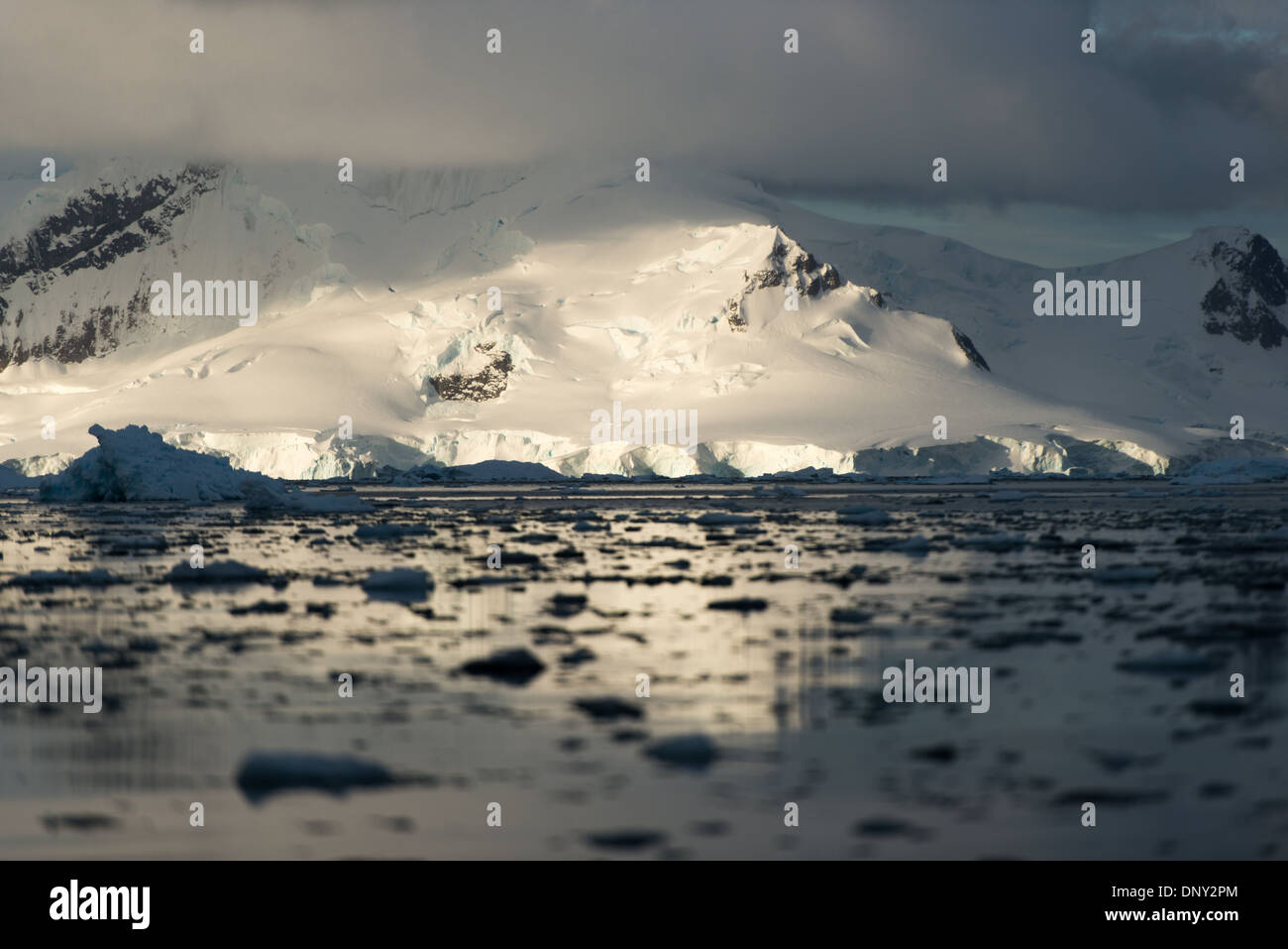 ANTARCTICA - The setting sun casts a beautiful orange glow on clouds ...