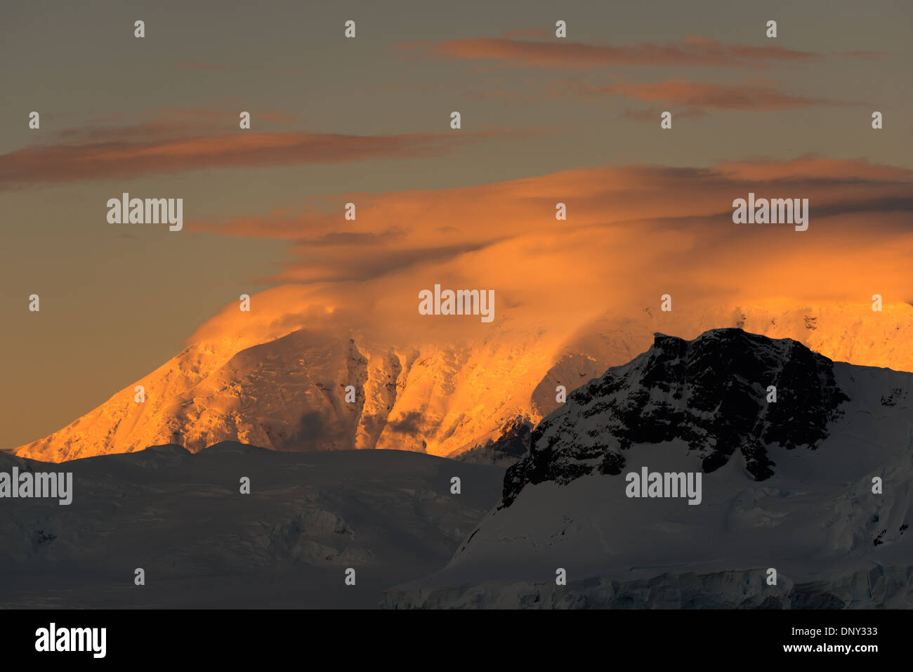 ANTARCTICA - The setting sun casts a beautiful orange glow on clouds ...