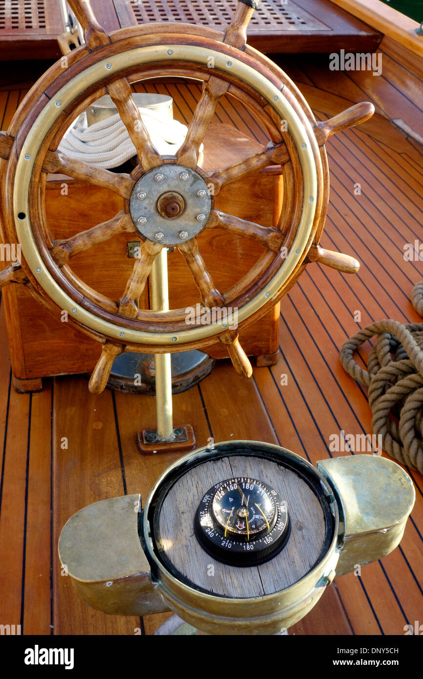Classic wooden helm wheel and a compass on a schooner Stock Photo - Alamy