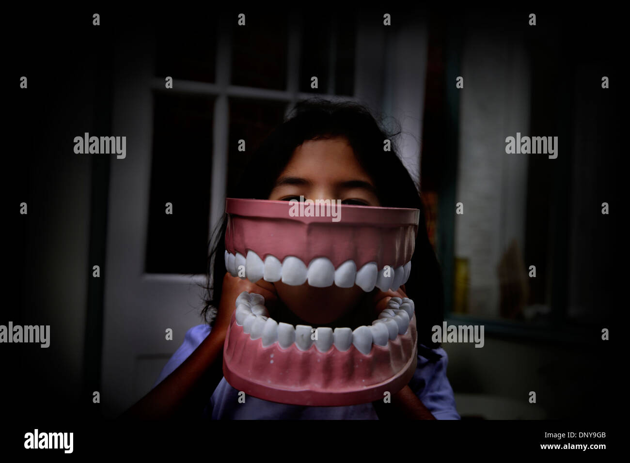 Child playing with giant toy teeth Stock Photo - Alamy