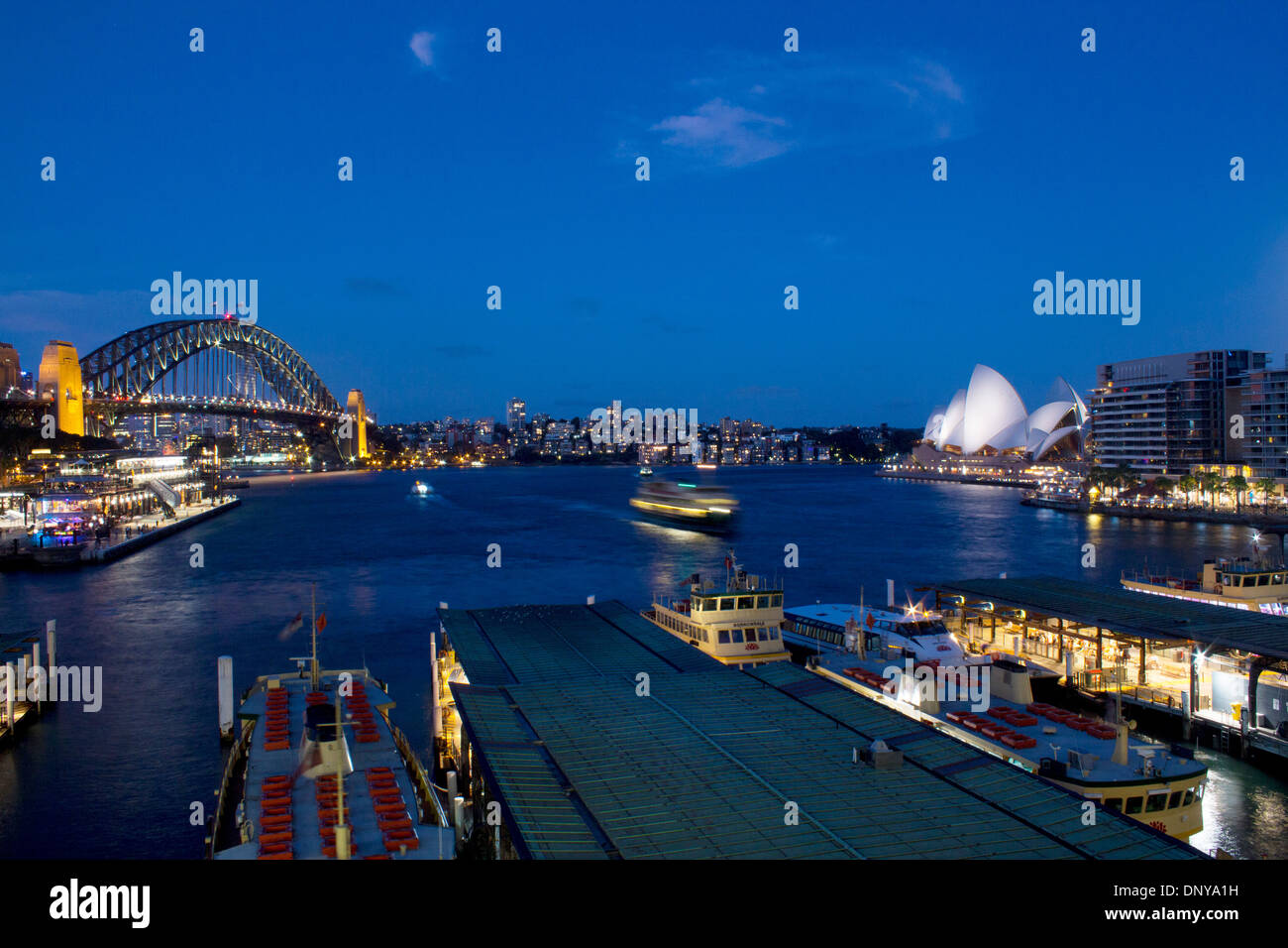 Circular Quay at night with ferries arriving, Harbour Bridge and Opera ...