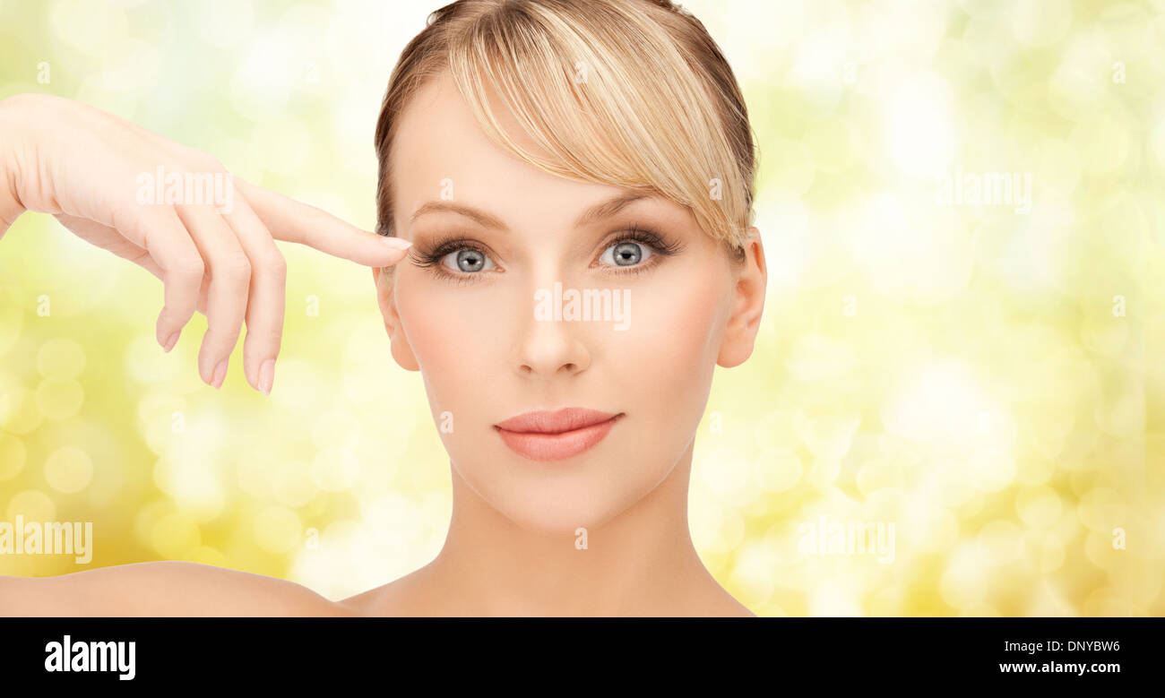 beautiful woman touching her eye area Stock Photo - Alamy