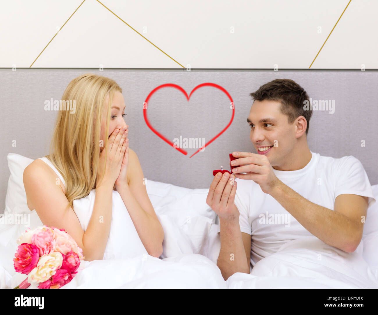 man giving woman little red box and ring in it Stock Photo - Alamy