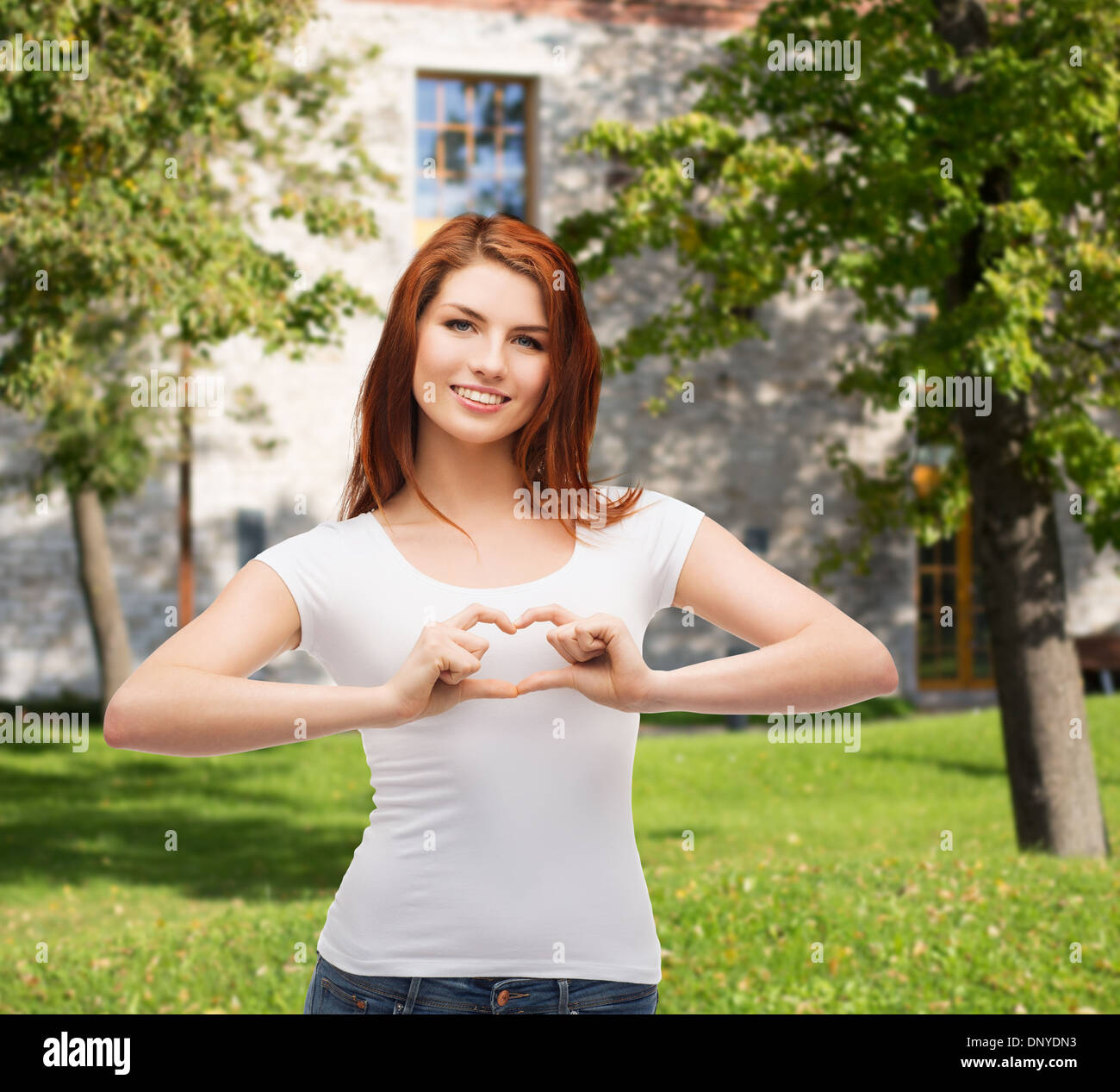 smiling girl showing heart with hands Stock Photo - Alamy