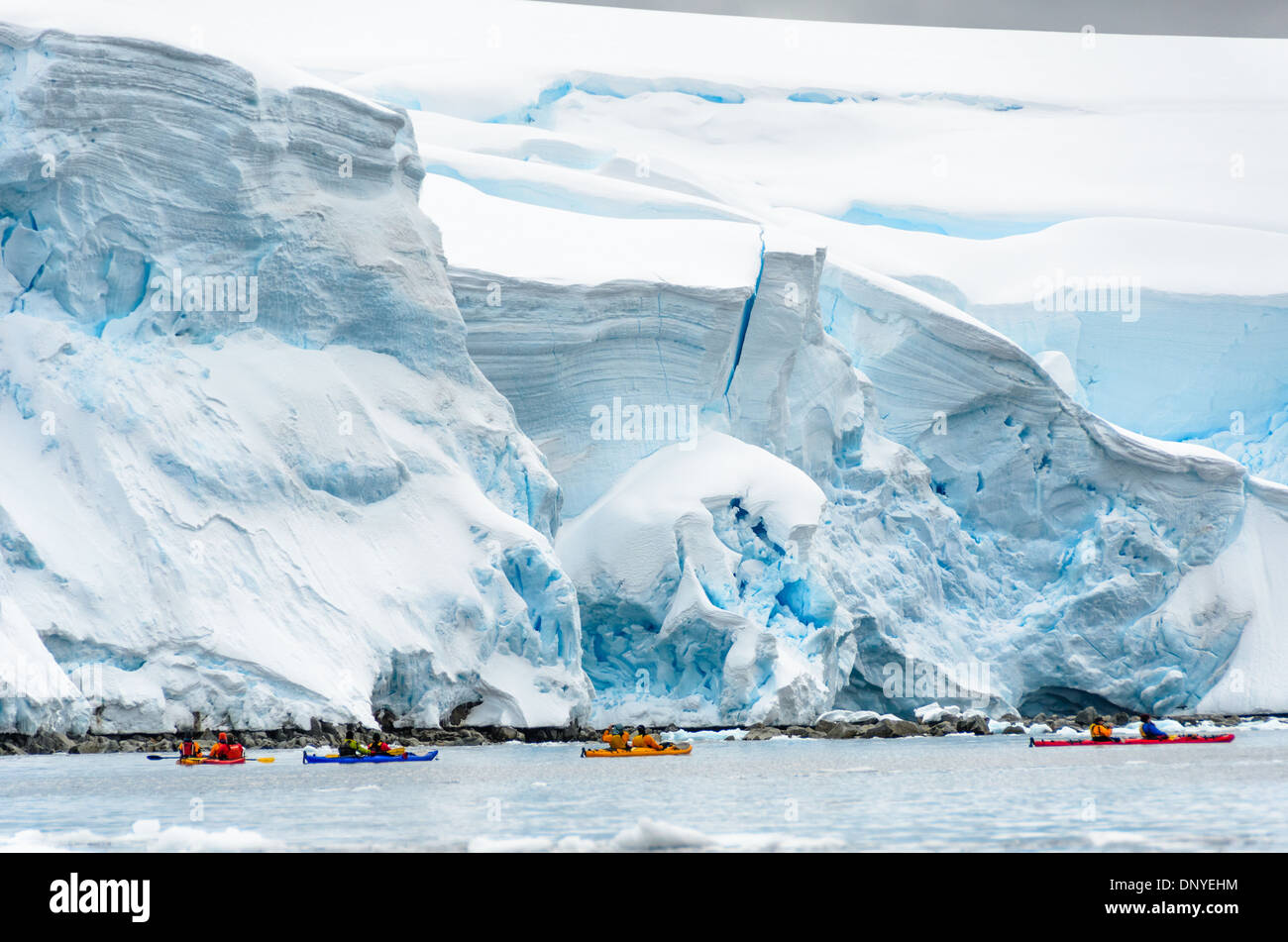 ANTARCTICA - Kayakers paddle past massive cliffs of glacial ice slowly ...