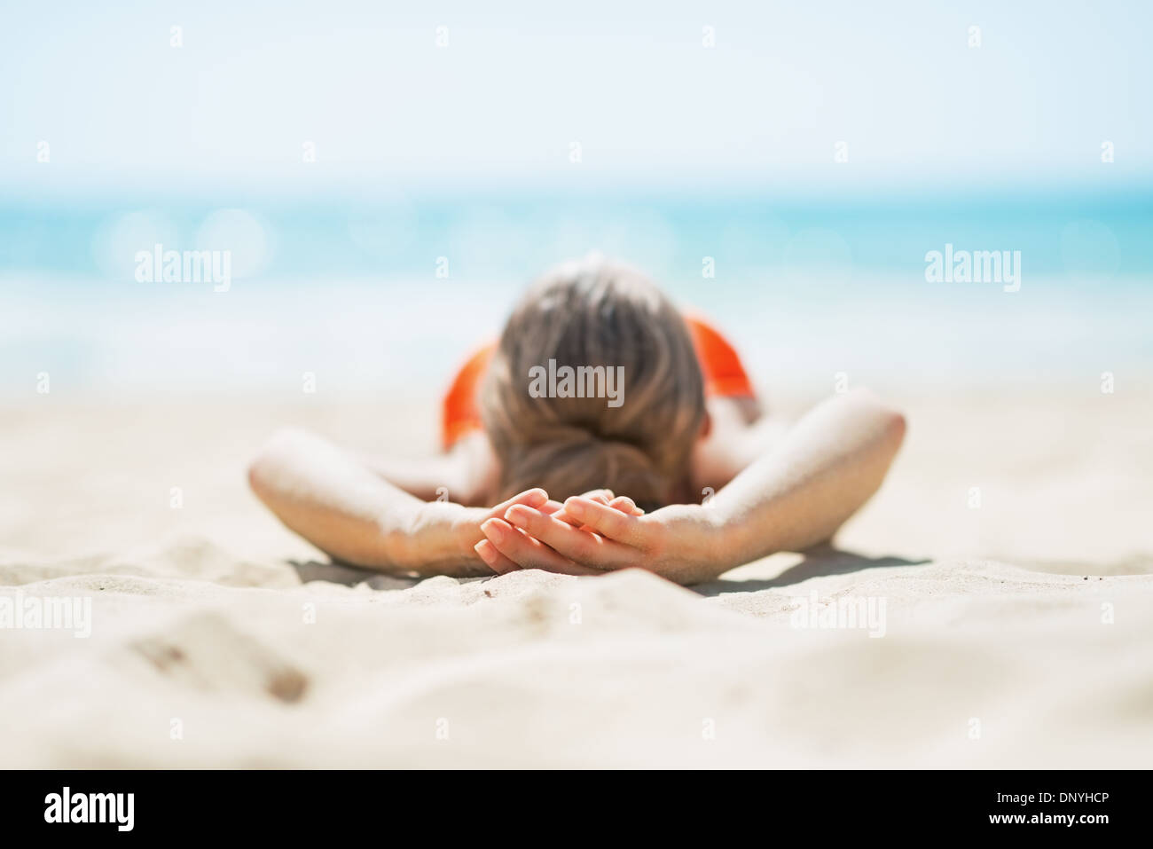 Young woman laying on beach. rear view Stock Photo - Alamy