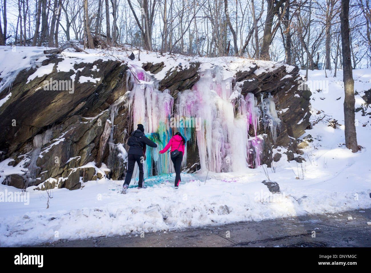 A waterfall comprised of colored icicles is seen on Dyckman Street in ...