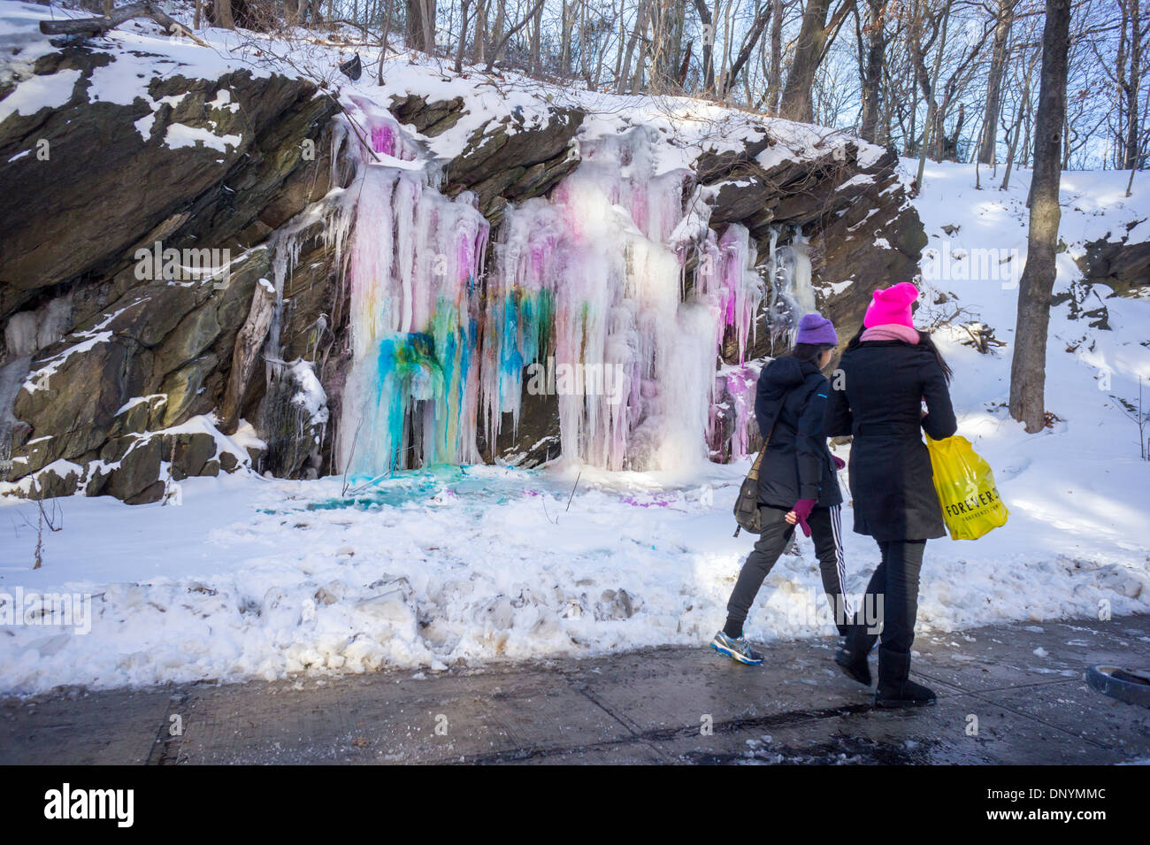 A waterfall comprised of colored icicles is seen on Dyckman Street in ...