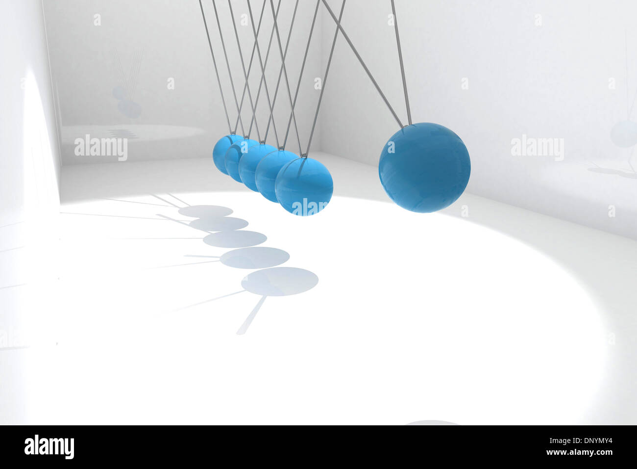 Blue newtons cradle Stock Photo - Alamy