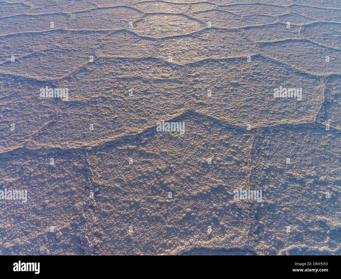 Patterns closely resembling hexagon shapes formed by salt crystals on ...