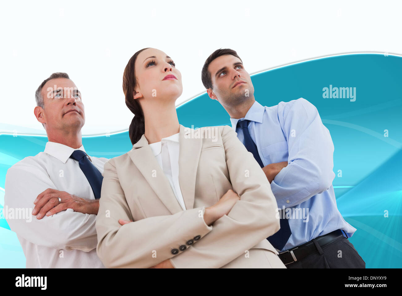 Composite image of serious work team posing together looking away on ...