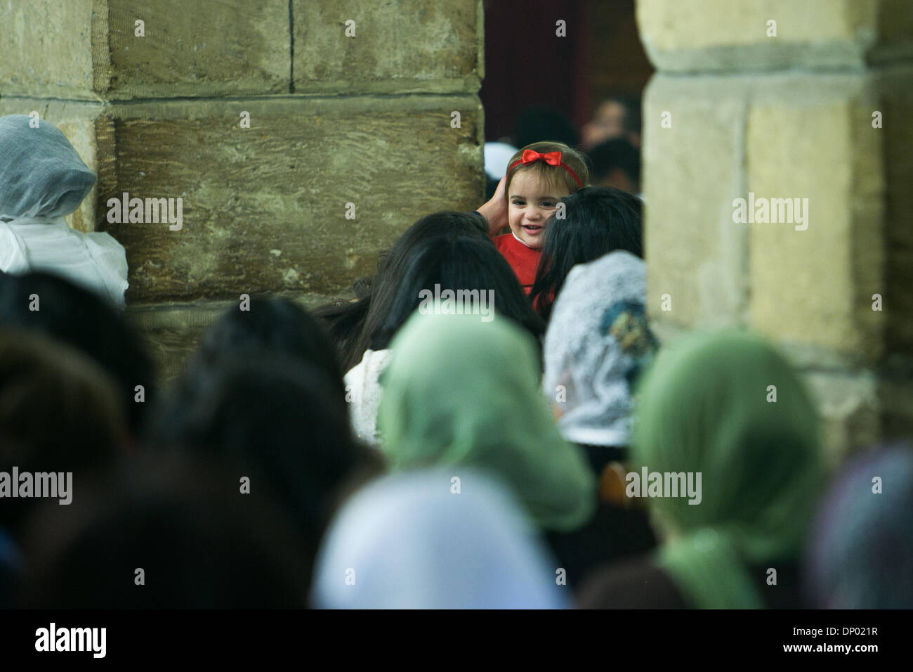 Cairo, Egypt. 7th Jan, 2014. A Coptic girl looks on during a Christmas ...