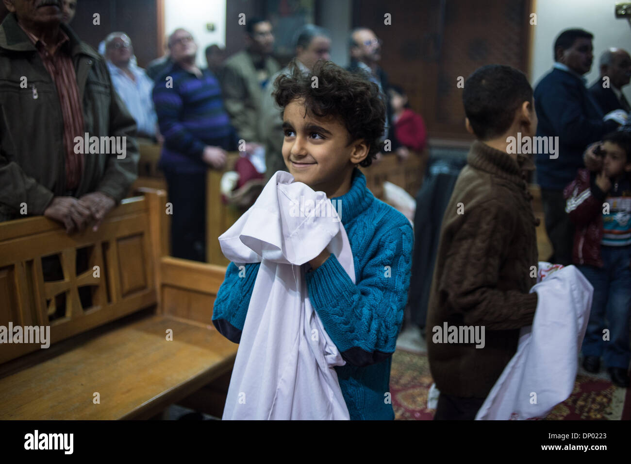 Cairo, Egypt. 7th Jan, 2014. A Coptic altar boy is to change clothes ...