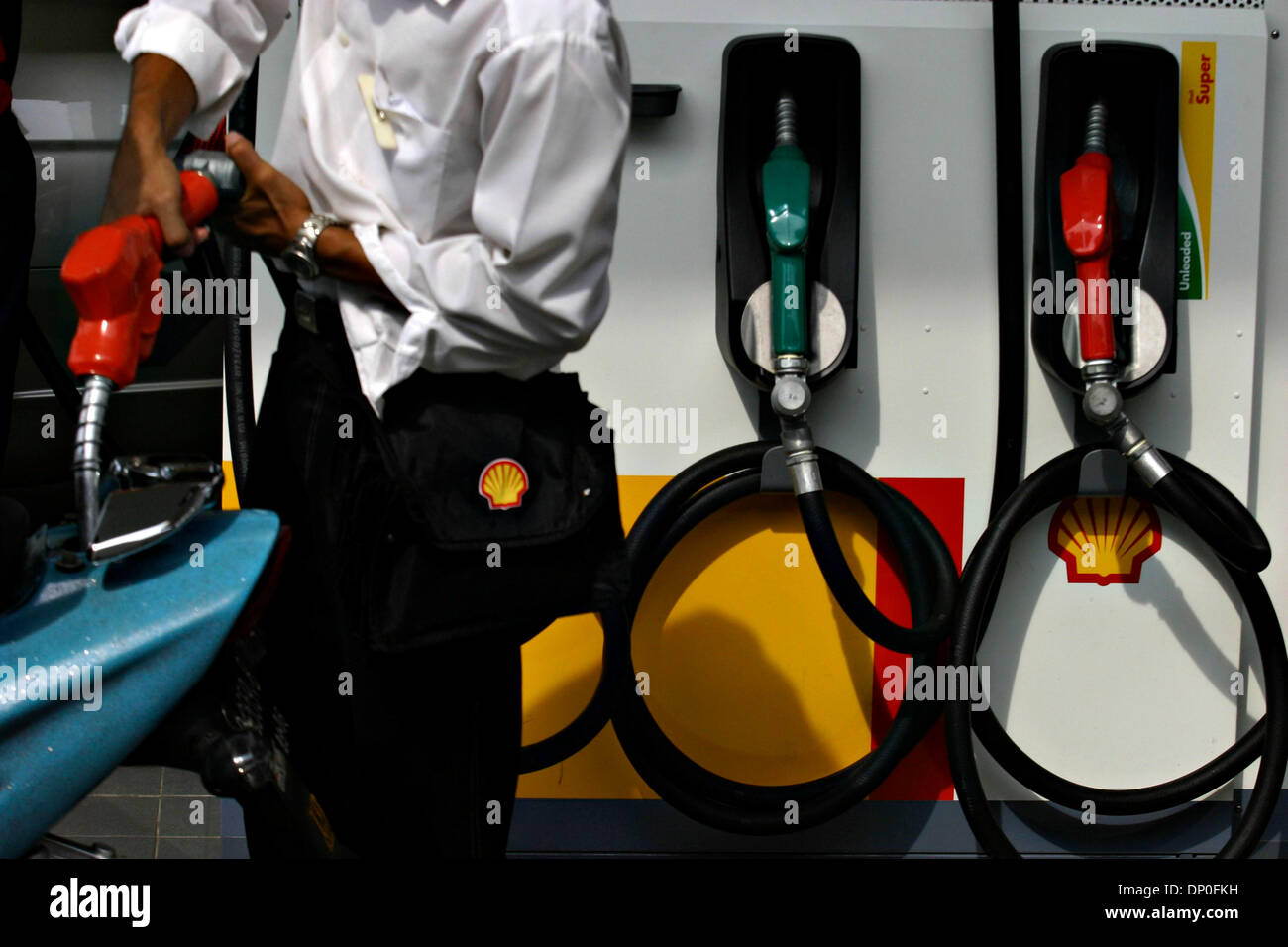 Mar 17, 2006; Jakarta, INDONESIA; A ShellÕs petrol station officer in ...