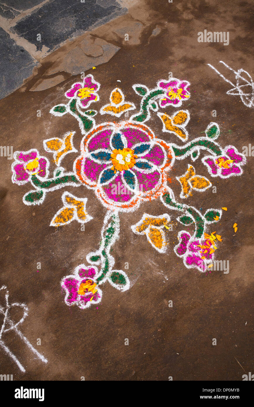 Rangoli festival coloured powder design and flowers in an Indian street ...
