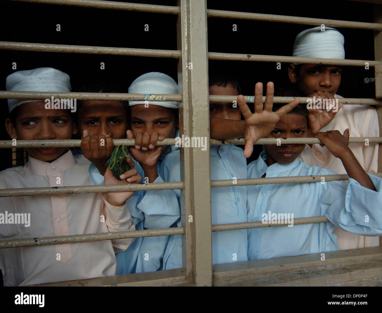 Mar 31, 2006; Chennai, Tamil Nadu, INDIA; Muslim oprhans peer through ...