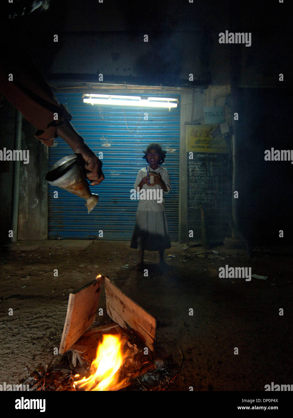 Mar 31, 2006; Chennai, Tamil Nadu, INDIA; A father pours gas on a fire ...