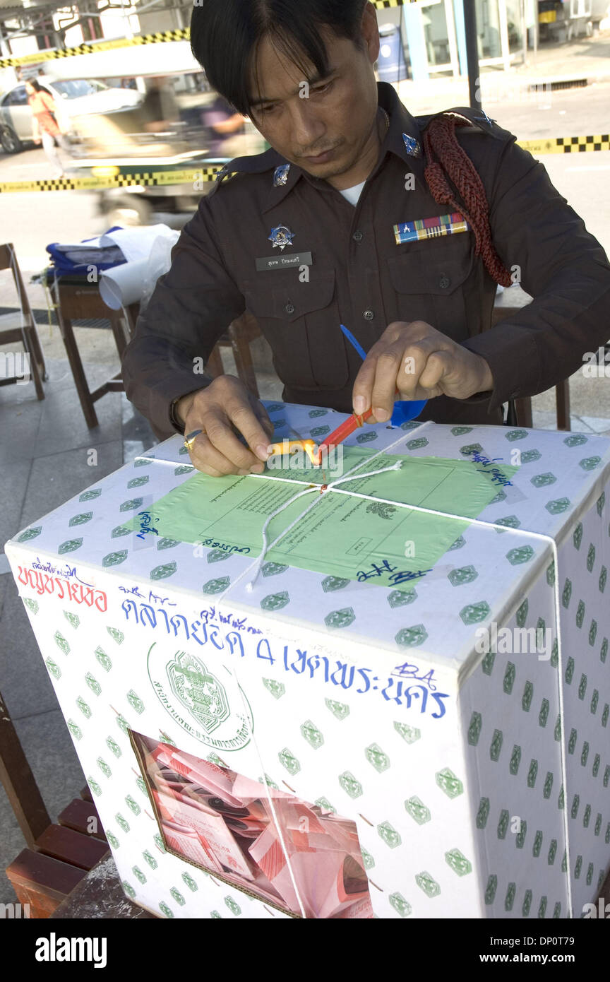 Apr 02, 2006; Bangkok, THAILAND; A police man seals a ballot box ...
