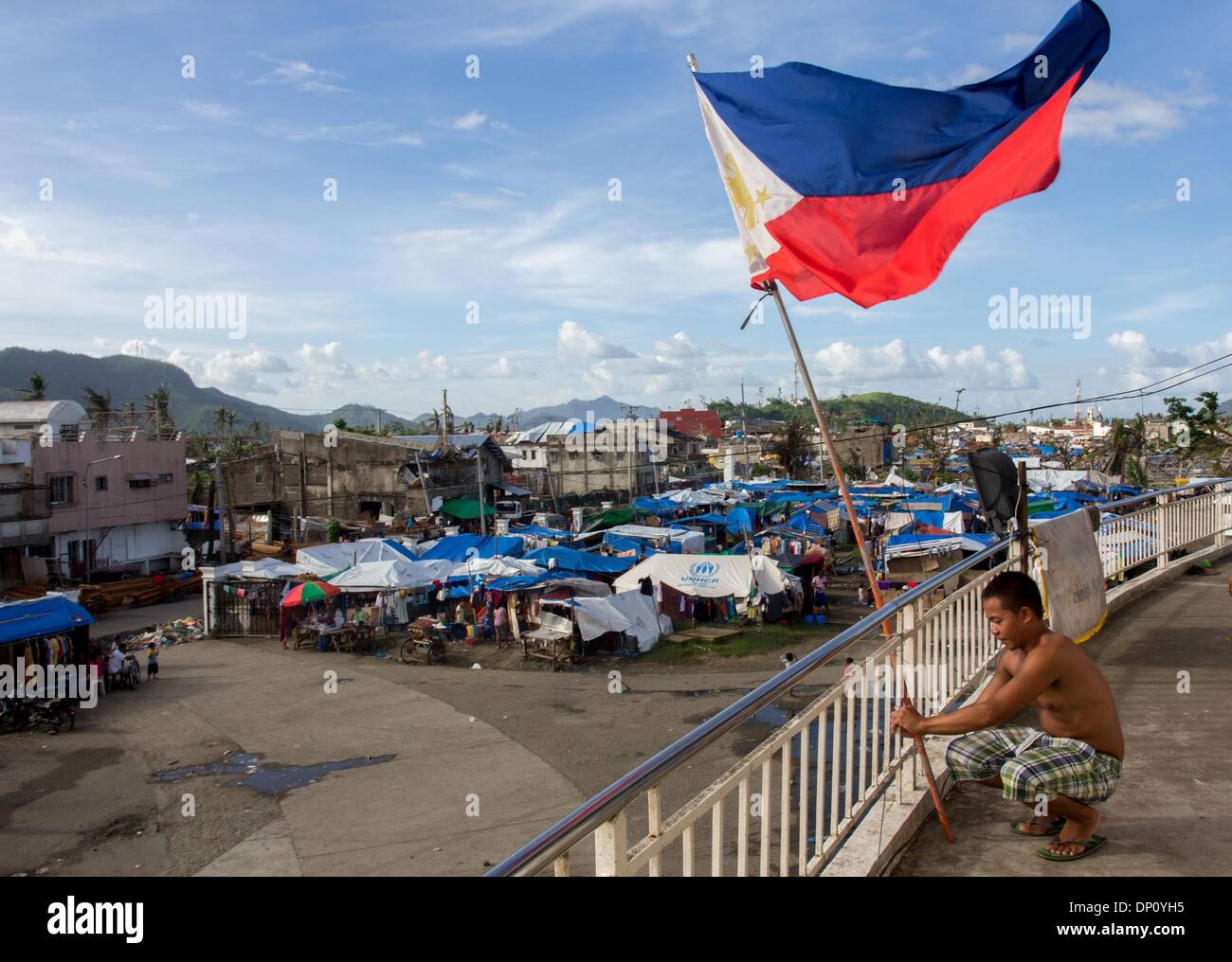 Tacloban City, Philippines. 5th Jan, 2014. A man fixing the Philippine ...