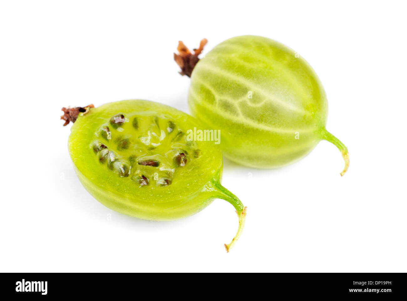 Whole and sliced green gooseberry fruit closeup with seed on white ...