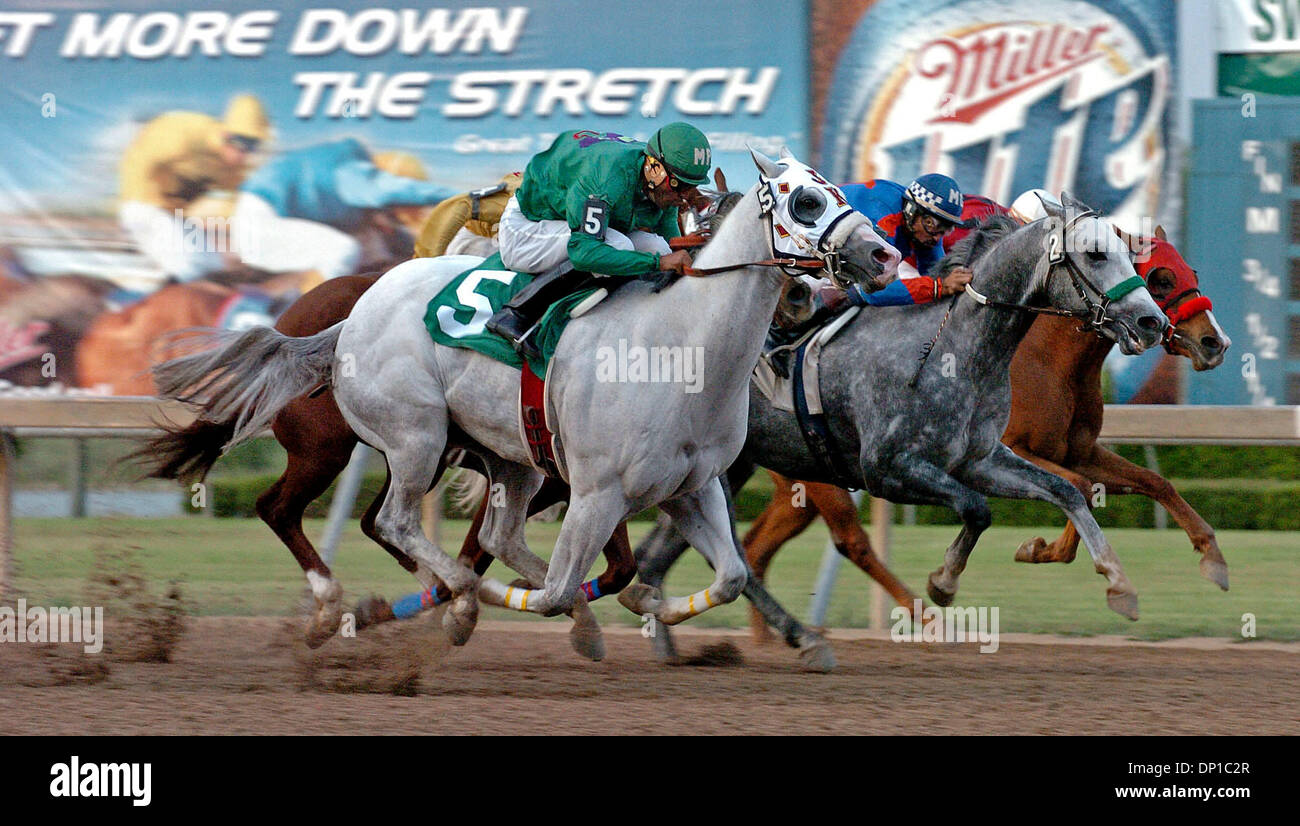 Apr 28, 2006; San Antonio, TX, USA; Zimarron (5) , riden by Modesto Pina, zooms out to the lead ...