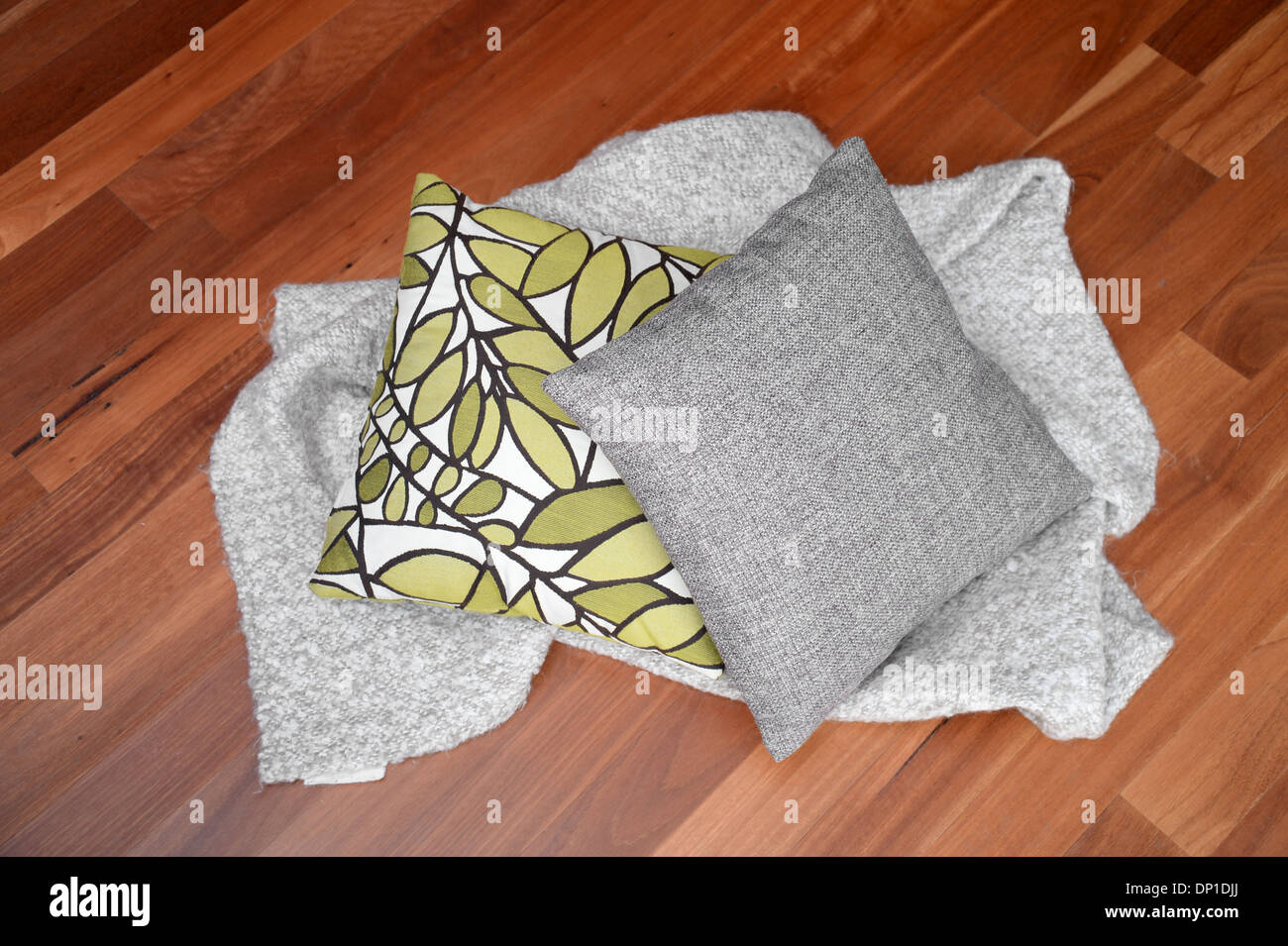 Scatter cushions isolated on a wooden floor Stock Photo - Alamy