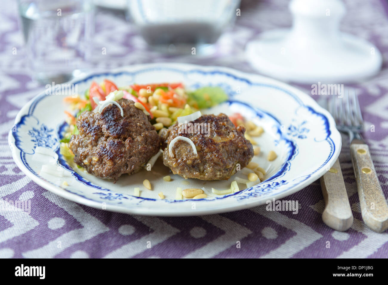 Minced beef meat ball burger patties with some salad on the side with ...